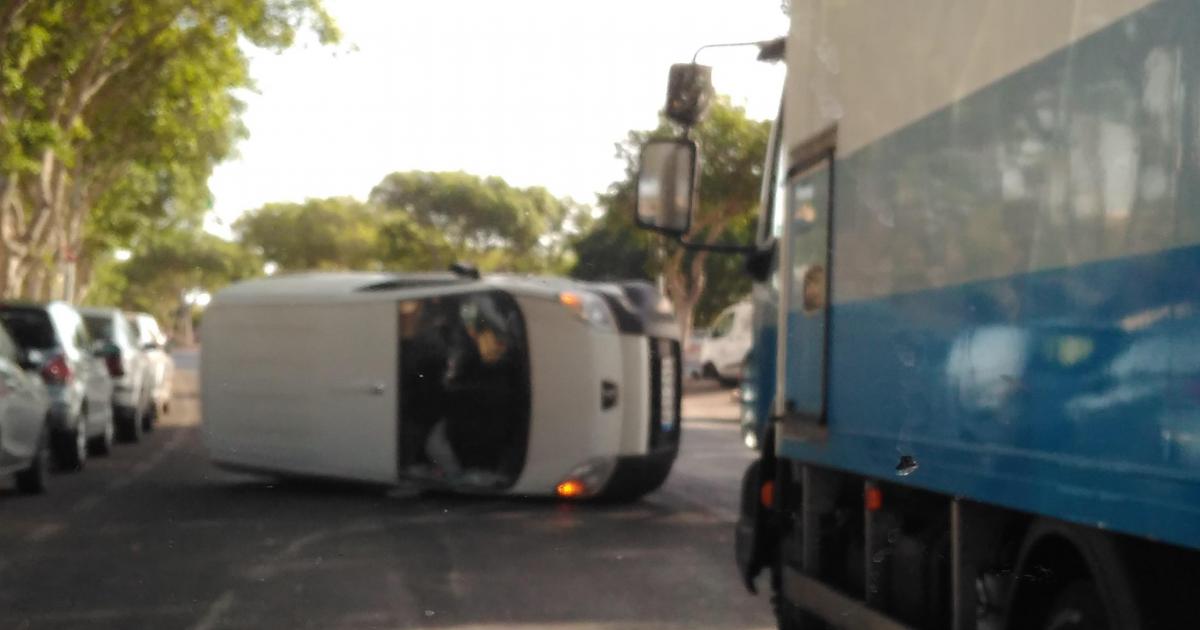 Driver escapes injury as van flips onto its side