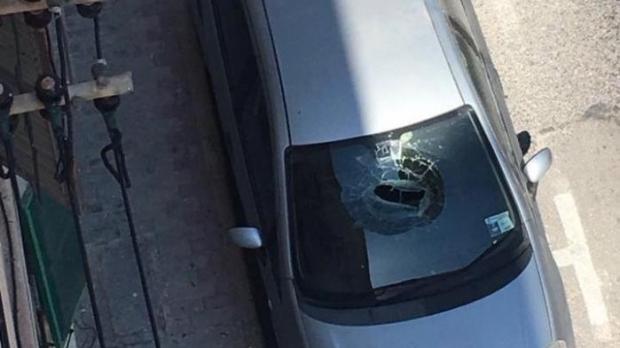 Falling stone crashes through parked car's windscreen