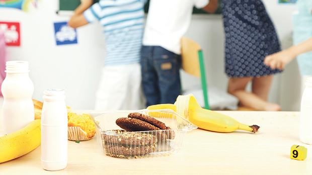 Teachers giving food to hungry students